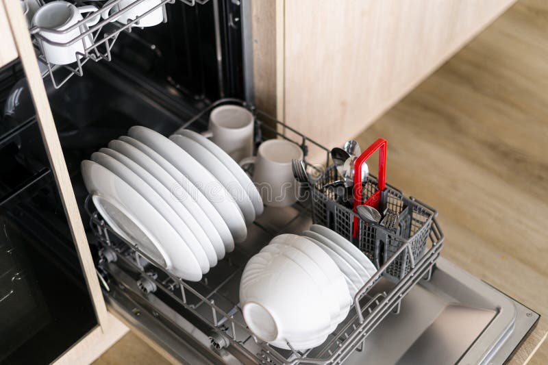 Dishwasher in a Kitchen with Open Door and Tableware Inside Stock Image ...