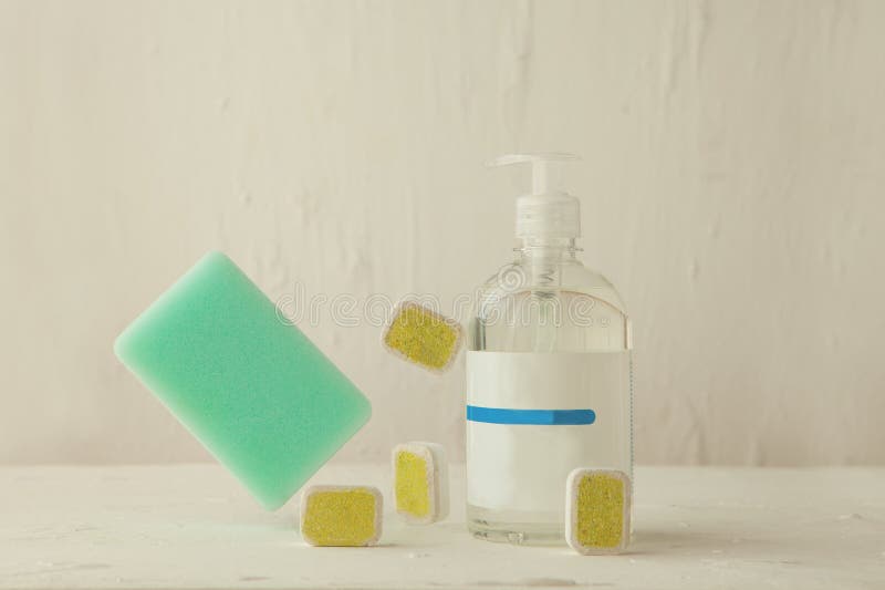 Dishwasher Tabs for Cleaning with Sponge. Washing Tablets and Liquid in ...