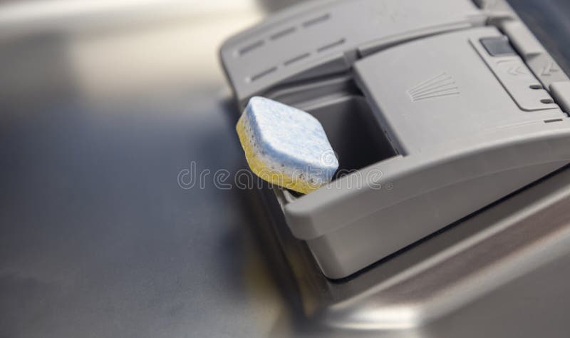 Dishwashing Concept. a Tablet for a Dishwasher, in a Container for a ...