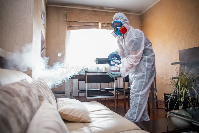 Disinfection of the Room Against Viruses. Man in Quarantine Clothes ...