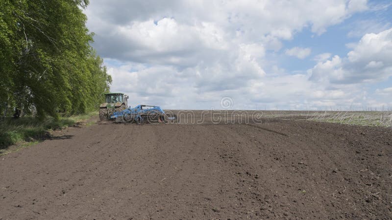 Disking the Soil. Short Disc Harrow. Work of Agricultural Machinery in ...
