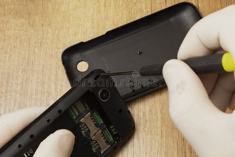 Dismantling an Old Phone for Repair on a Table Stock Image - Image of ...
