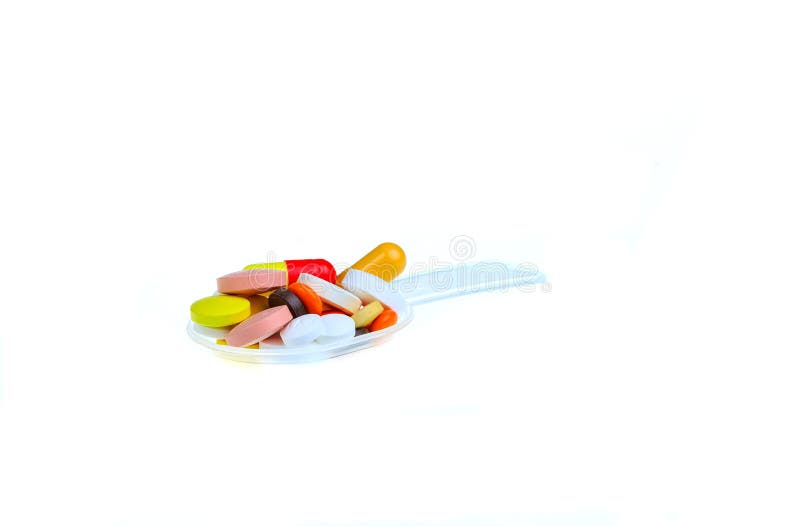 Dispenser Spoon with Tablets and Capsules on a White Background ...