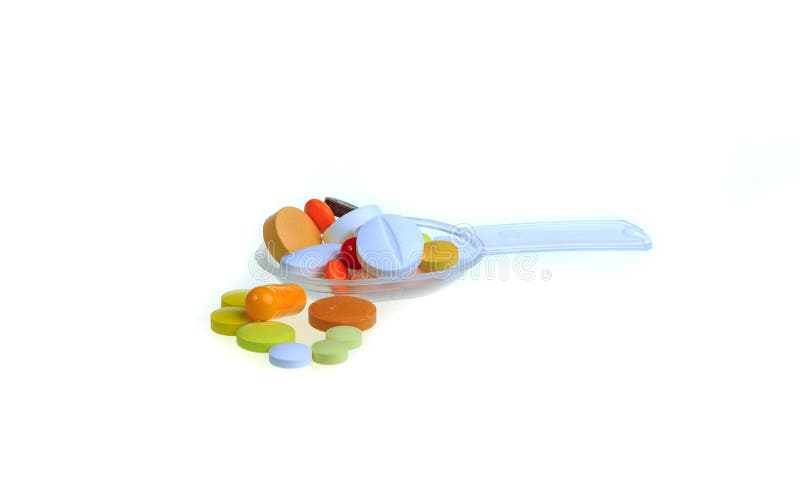 Dispenser Spoon with Tablets and Tablets and Capsules on a White ...