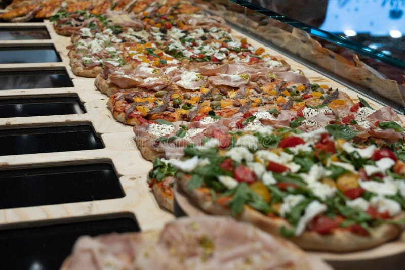 Display of a Bakery Counter with Stuffed Pizzas in Many Tastes Stock ...