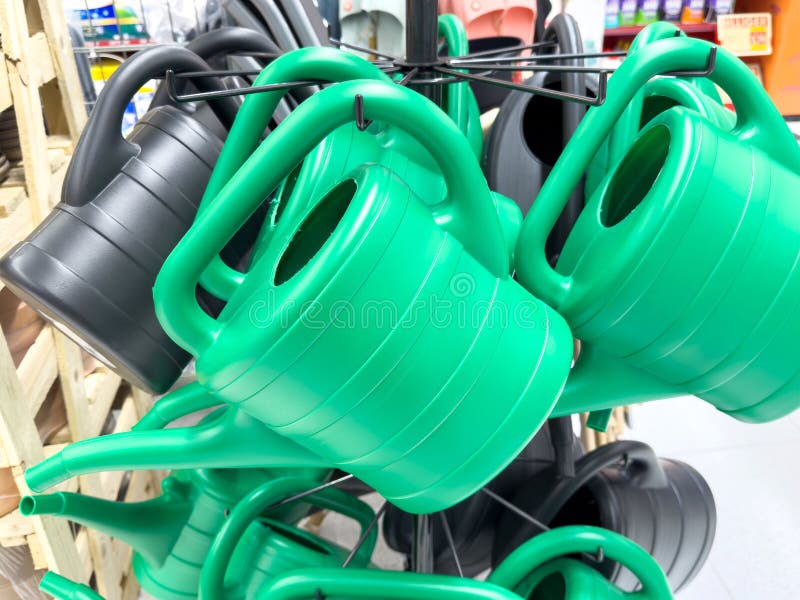 Display of Green and Black Plastic Watering Cans in a Store Editorial ...