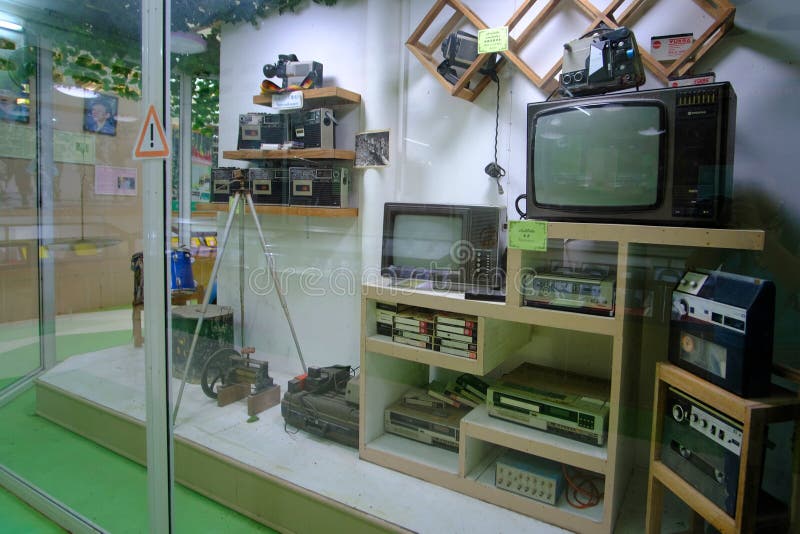 A Display of Old Electronics Including a TV, VCR, and a Camera ...