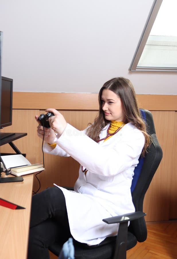 A Display of a Young Female Doctor Playing on a Computer. Ph5 Stock ...