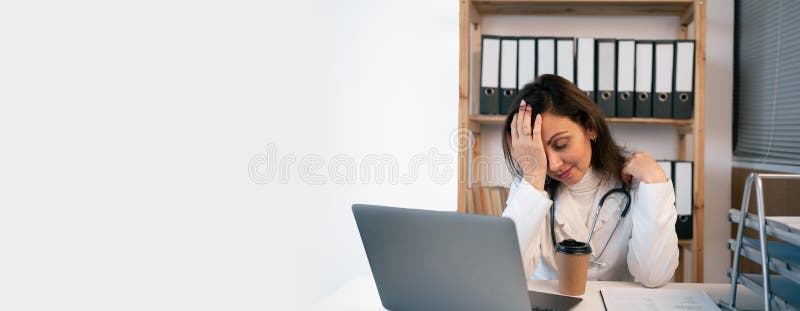 Displeased Tired Doctor Using Computer and Reading an E-mail at Doctor ...