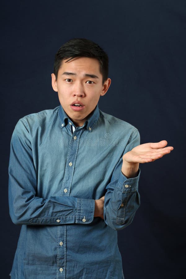 Displeased Young Asian Man Gesturing with One Hand Stock Photo - Image ...