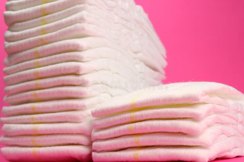 Disposable Diapers in a Stack on a Pink Background Close-up Stock Image ...