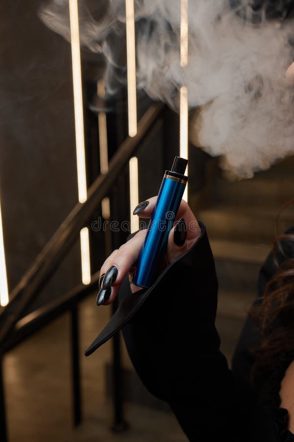 Disposable Electronic Cigarettes in Hand. the Concept of Modern Smoking ...