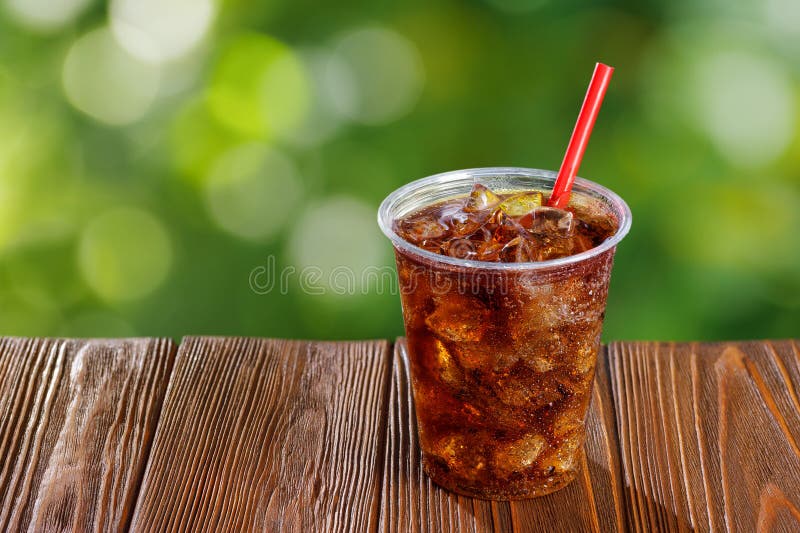 Disposable Glass with Iced Cola on Wooden Table Outdoors Stock Photo ...