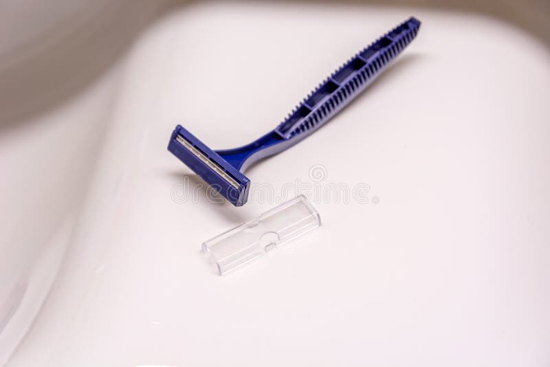 A Disposable Plastic Razor Lying on the Sink Stock Photo - Image of ...