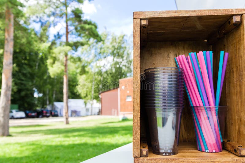 Disposable Plastic Cups and Straws in a Wooden Box Stock Photo - Image ...