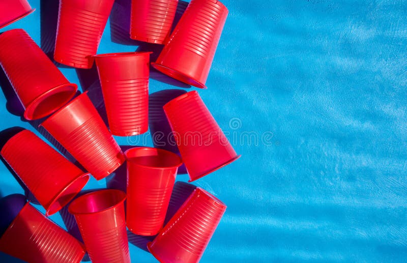 Disposable Plastic Tableware. Red Glasses of Red Color on a Blue ...