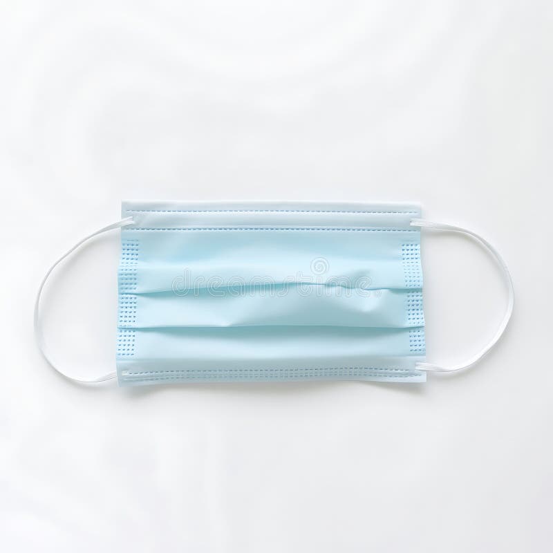 A Disposable Surgical Mask with Elastic Ear Loops Lying Flat on a White ...