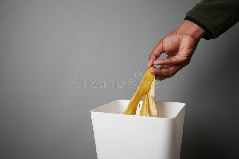 Disposing of Banana Peels in a White Trash Bin at Home Stock Photo ...