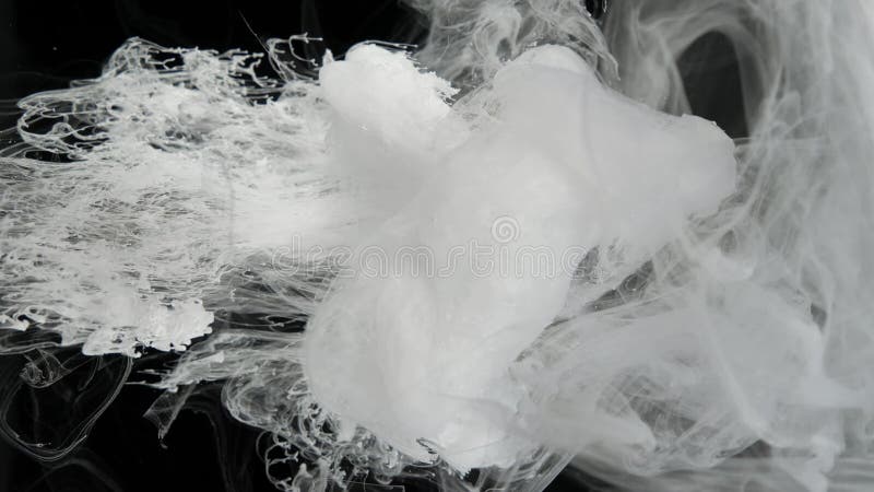 Dissolution of White Paint on a Black Background. Injection of Paints ...