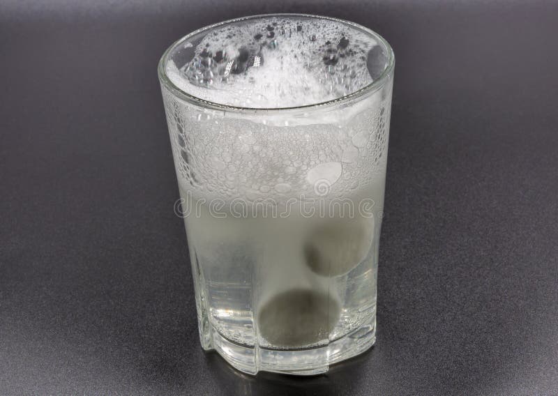 Dissolving Instant Effervescent Tablets in a Glass of Water Closeup ...