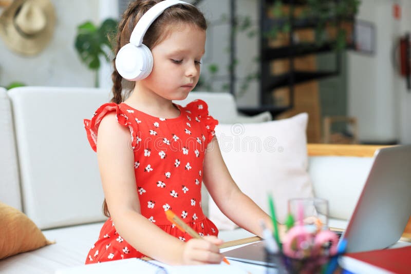 Distance Learning. Cheerful Little Girl Using Laptop Computer Studying ...