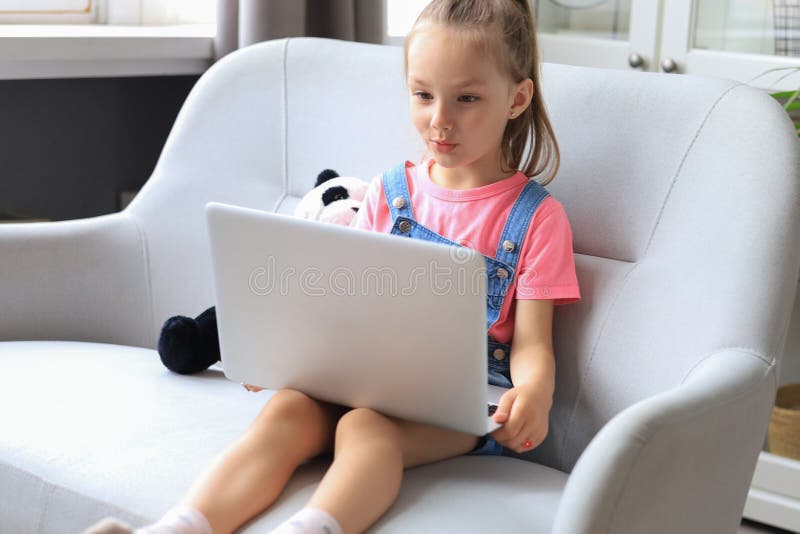 Distance Learning. Cheerful Little Girl Using Laptop Computer Studying ...