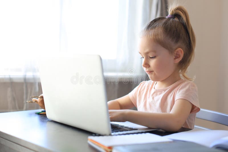 Distance Learning. Cheerful Little Girl Using Laptop Computer Studying ...