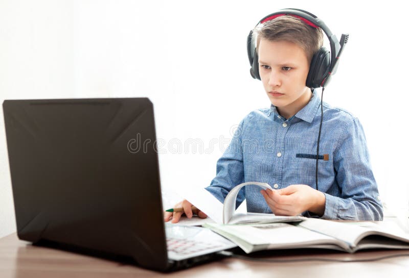 Distance Learning in Quarantine. a Boy in Headphones in Front of a ...
