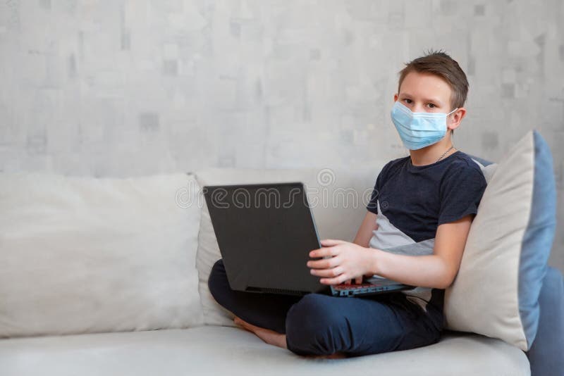 Distance Learning in Quarantine. a Boy in a One-time Mask Does Homework ...