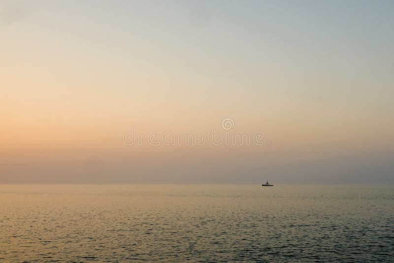 Distant Cargo Ship in a Calm Sea at Evening Editorial Stock Image ...
