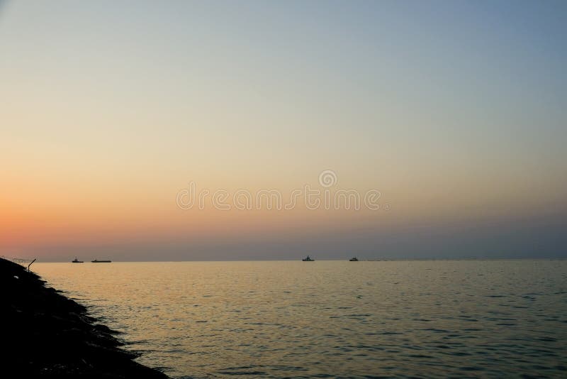 Distant Cargo Ships in a Calm Sea at Evening Stock Image - Image of ...