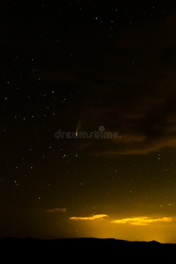 A Distant Comet in the Evening Sky with Stars Stock Photo - Image of ...