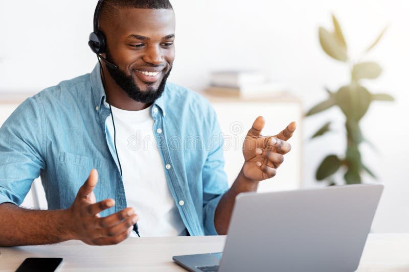 Distant Communication. Happy African American Guy in Headset Making ...