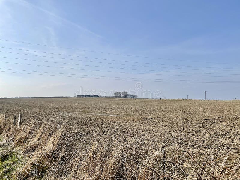 Distant Farm Over Shadowed by Large Field Stock Photo - Image of wind ...