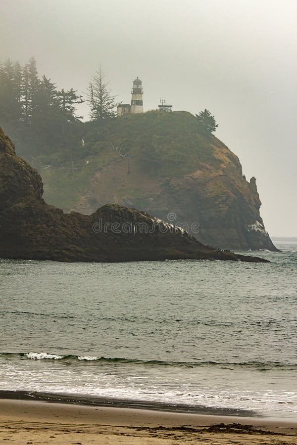 Distant Lighthouse on a Large Cliff Over a Cold Ocean Stock Image ...