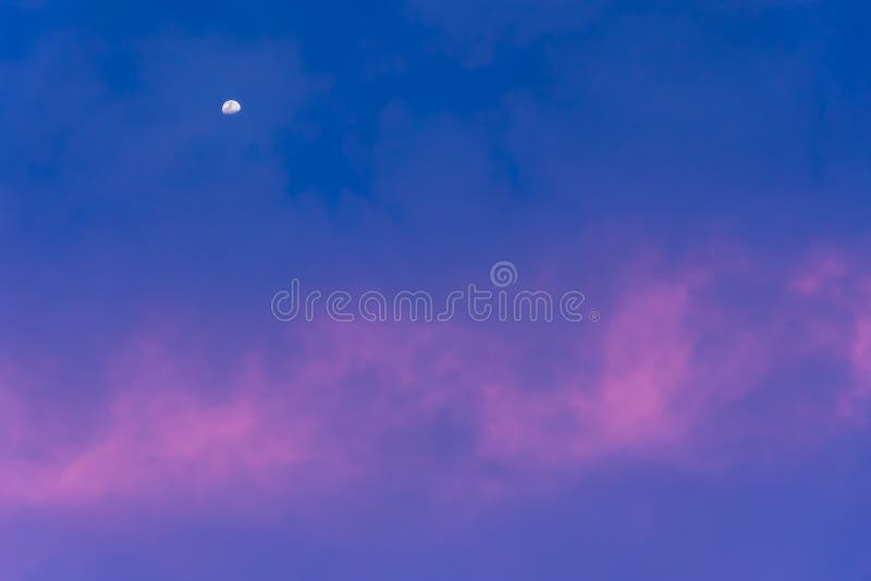 A Distant Moon in the Early Evening Sky Stock Photo - Image of cloud ...