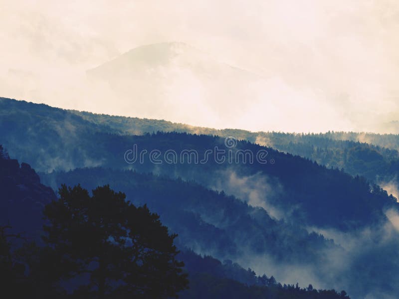 Distant Mountain Range and Heavy Clouds of Colorful Mist Above Deep ...