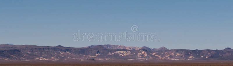 A Distant Mountain Range Under a Blue Sky Stock Photo - Image of ridge ...