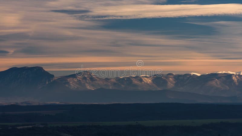 Distant Mountains at Sunset Stock Photo - Image of covered, valley ...