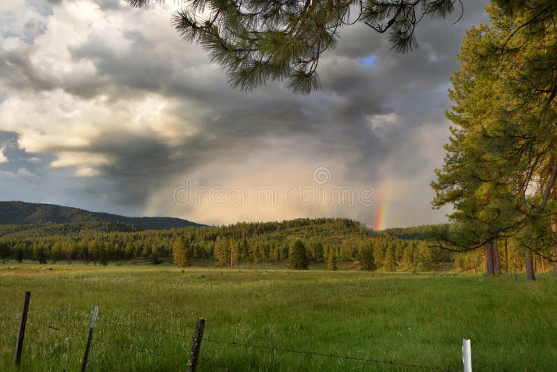 Distant Rainbow in the Breaking Clouds Stock Image - Image of sunlight ...