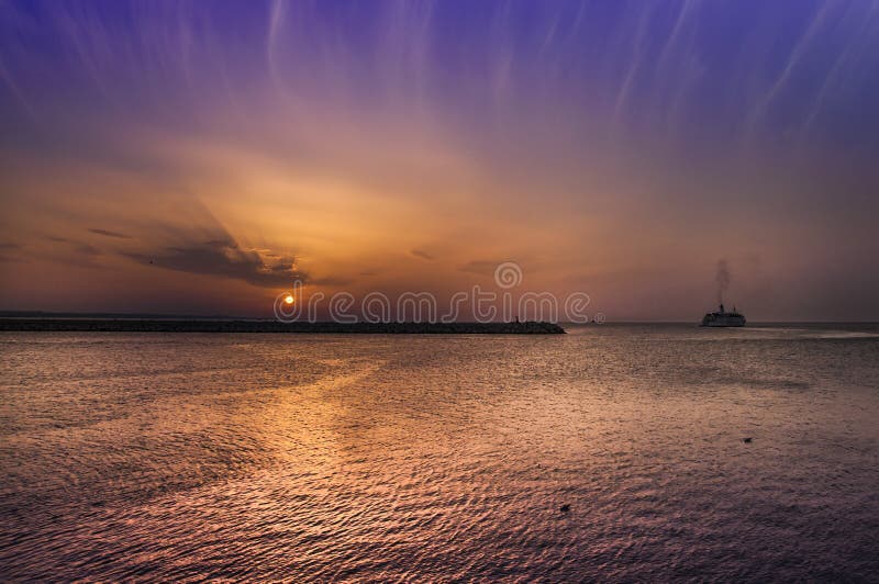 Distant ship at sunset stock photo. Image of distant - 74751998