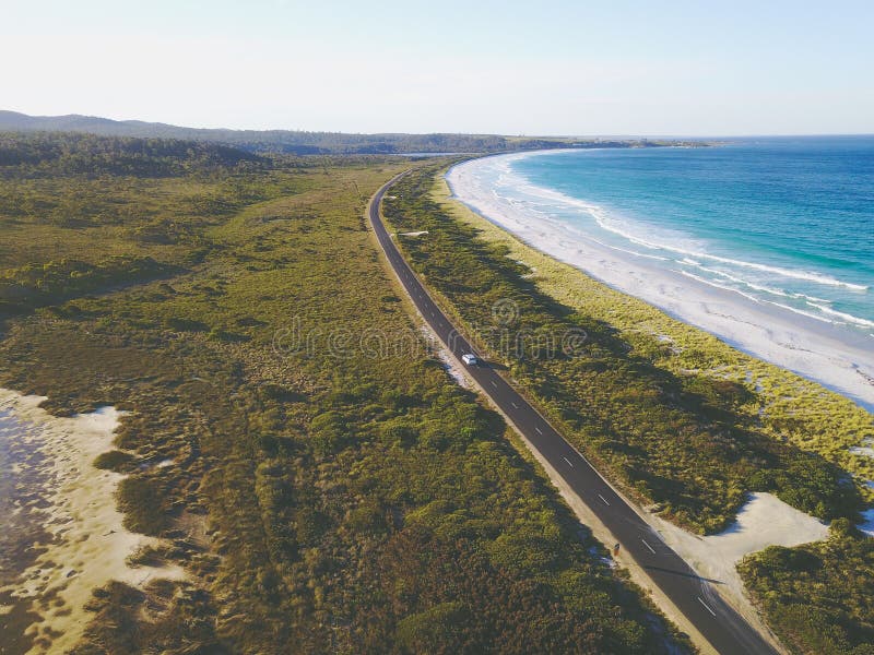 Distant Shot of a Highway Road Near Sea Surrounded by Green Fields ...