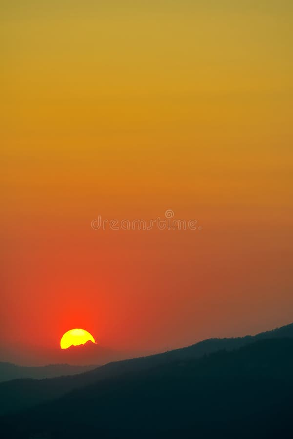 Distant Sunset Over the Silhouetted Mountain Range Stock Image - Image ...