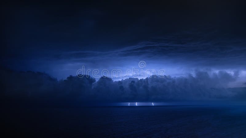 A Distant Thunderstorm Front Over the Sea Stock Photo - Image of ...