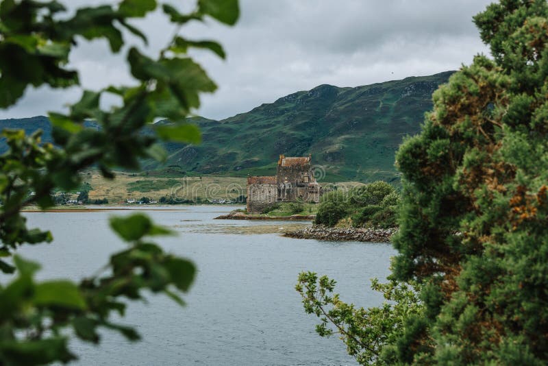 Distant View of the Eilean Donan Castle at the Coast of a River in Skye ...
