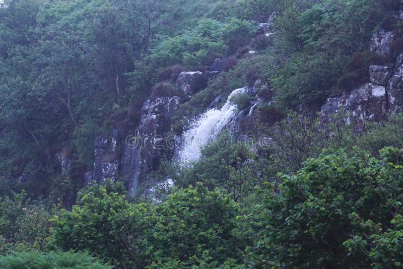 Distant View of Waterfall Running Over Rocks Stock Photo - Image of ...