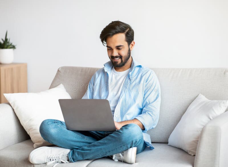Distant Work. Happy Arab Freelancer Man Using Laptop Computer at Home ...