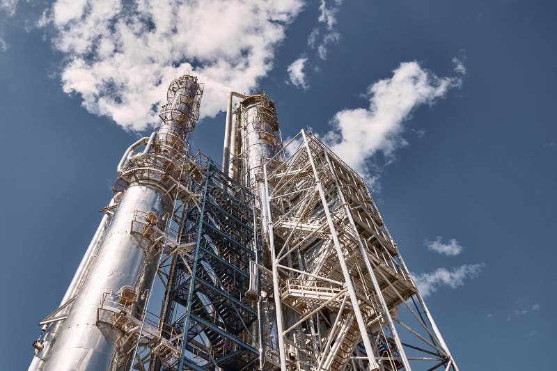 Distillation Columns Towering Over a Chemical Plant Under a Bright Sky ...