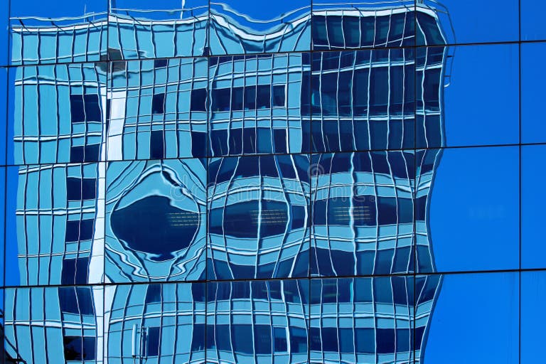 Distorted Reflection in a Wall of Glass Office Building Stock Photo ...