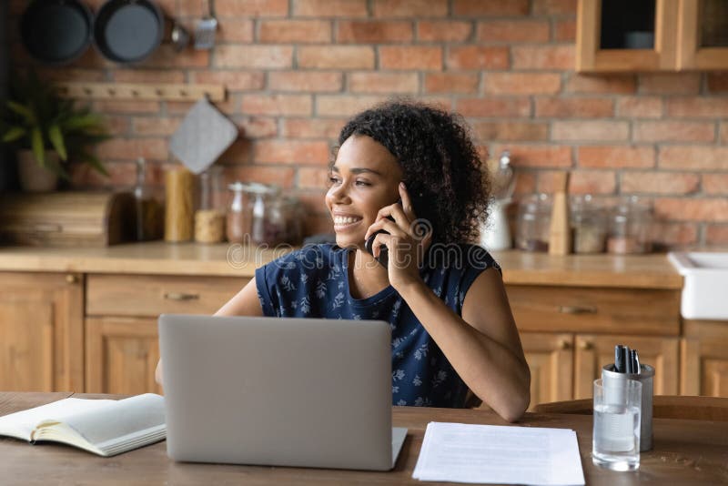Distracted from Computer Work Young Biracial Woman Holding Cellphone ...